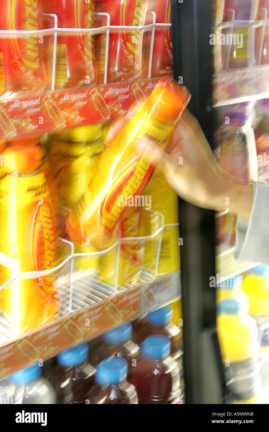 PERSON BUYING FIZZY DRINK FROM RACK Stock Photo - Alamy