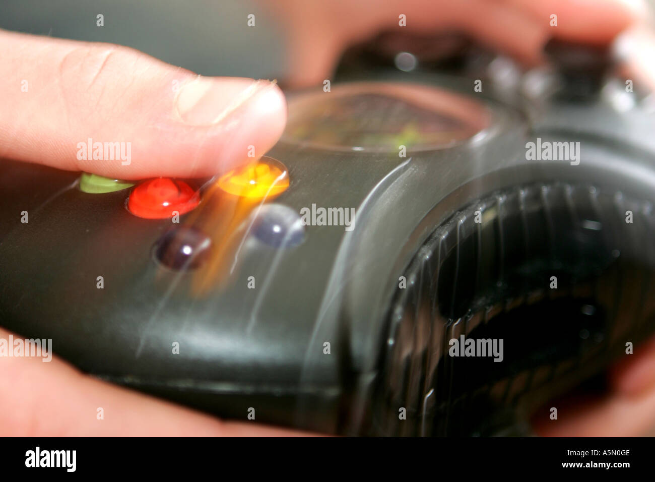 A PERSONS HANDS PLAYING A GAMES CONSOLE JOYPAD Stock Photo - Alamy