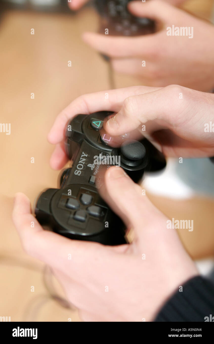 TWO PEOPLES HANDS PLAYING GAMES CONSOLE JOYPADS Stock Photo - Alamy