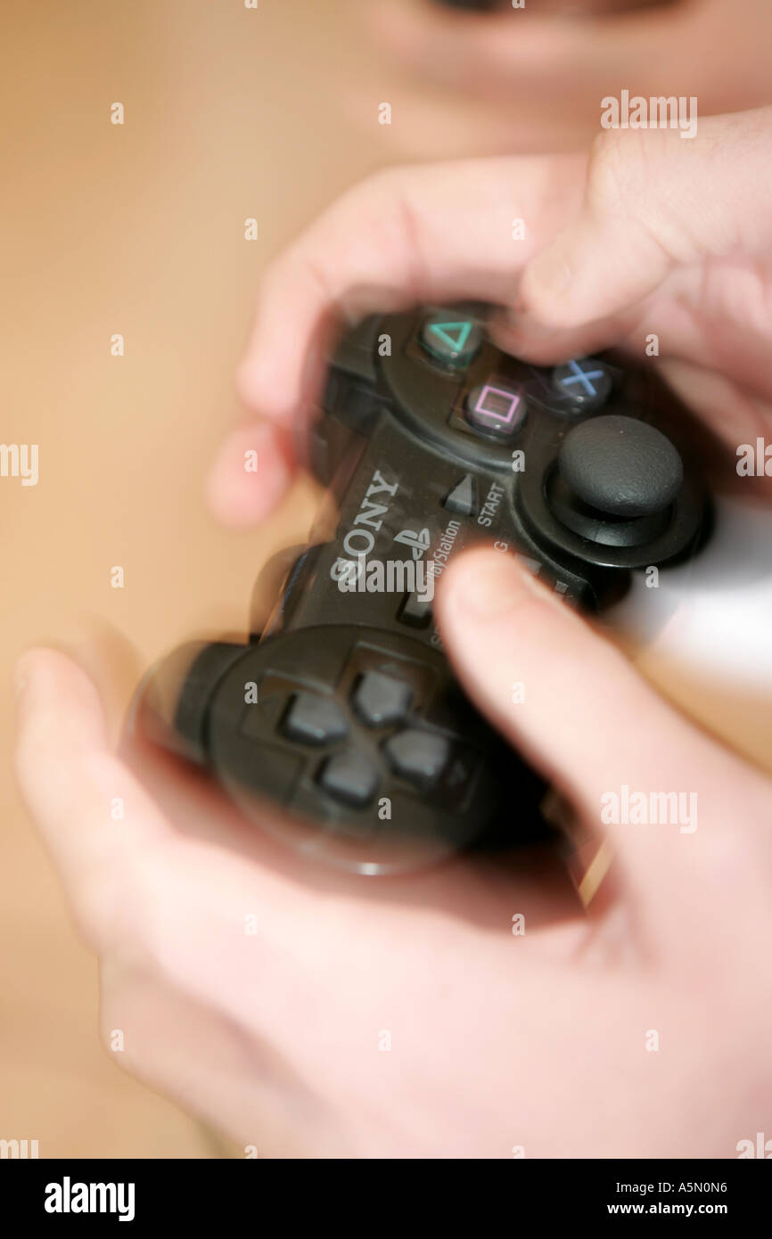 A PERSONS HANDS PLAYING A GAMES CONSOLE JOYPAD Stock Photo - Alamy