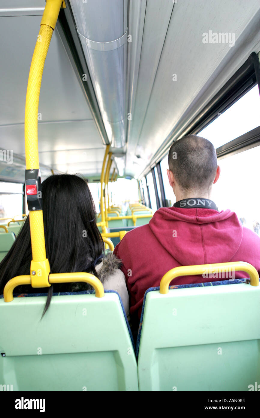 BACK OF MALE AND FEMALE SITTING DOWN ON A BUS Stock Photo - Alamy