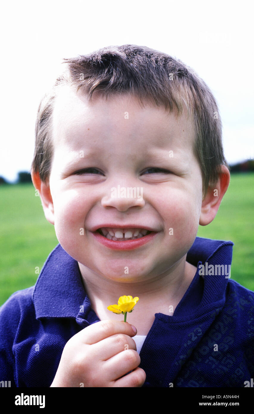a young boy with a buttercup Stock Photo - Alamy