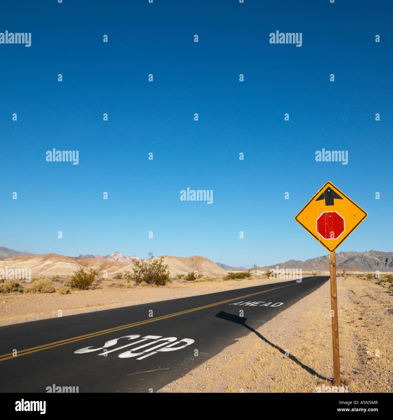 Road in desert with stop sign up ahead Stock Photo - Alamy