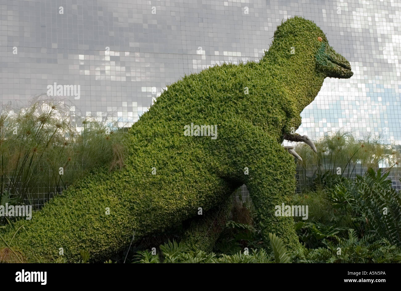 Green dinosaur topiary outside Universe of Energy building Epcot Walt ...