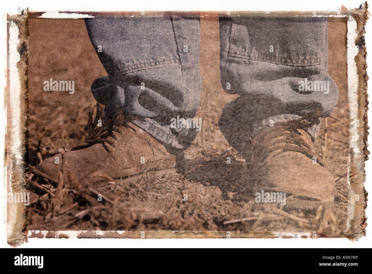 Polaroid transfer of feet shot of man wearing workboots standing in ...