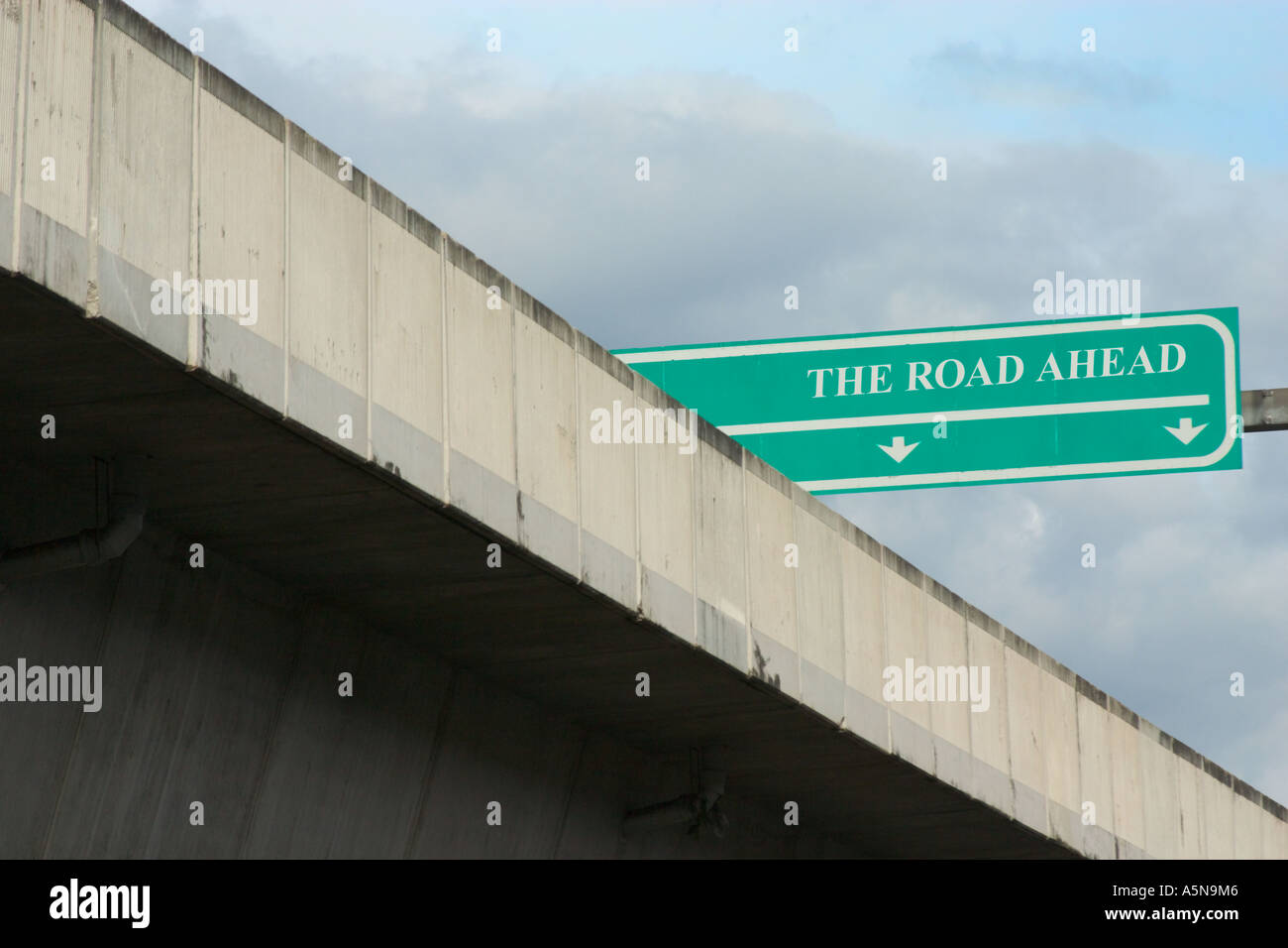 signboard with the words "the road ahead" and arrow on freeway Stock ...