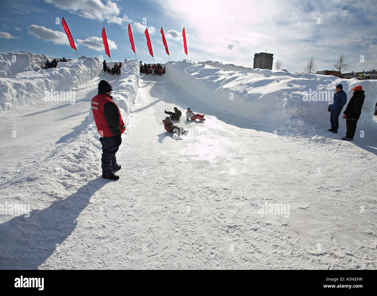 Icy Slide: Three youngsters slide down an icy snow slide at Ottawa's ...