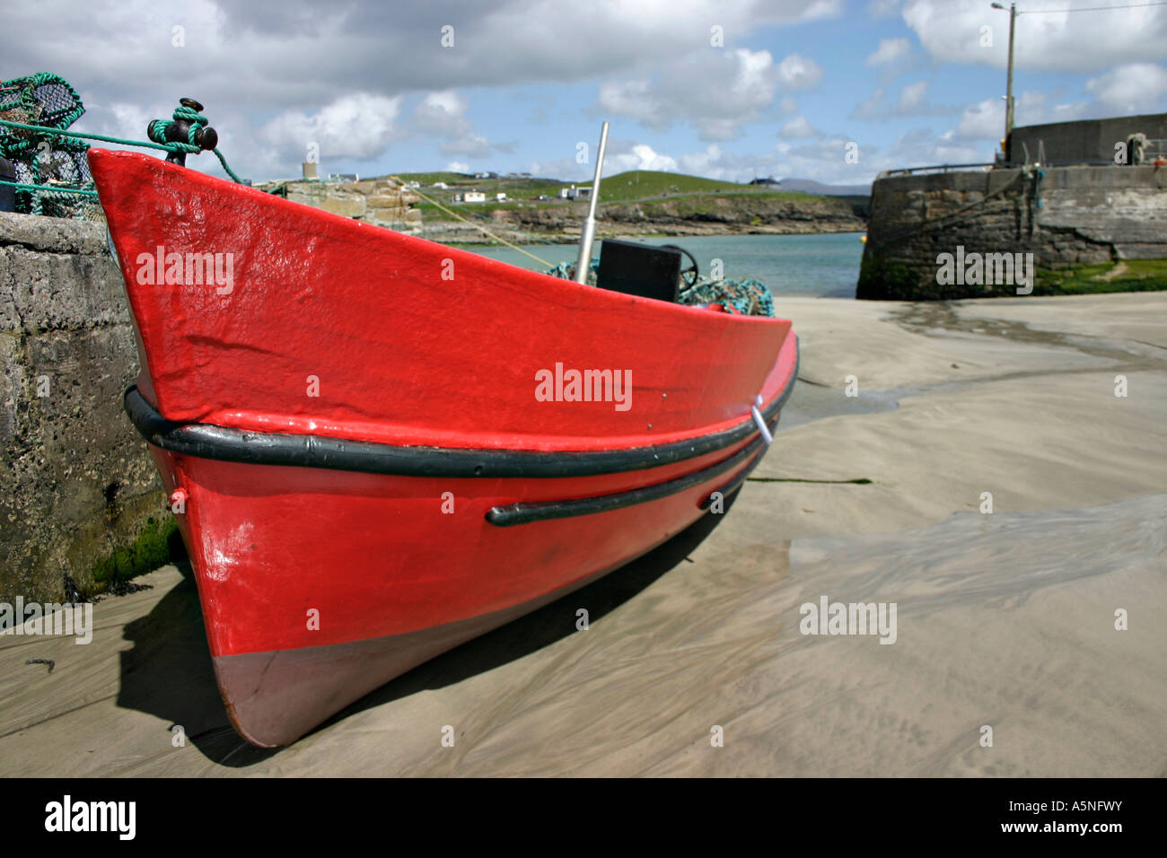 Beached Red Fishing Boat Stock Photo - Alamy