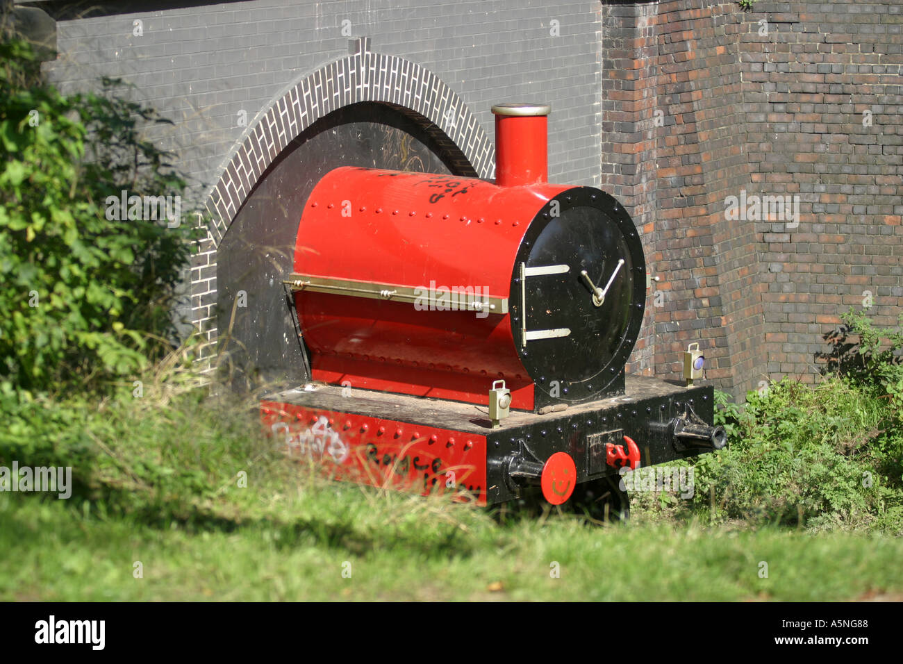 A train coming out of a tunnel The shell of an old steam train has been ...