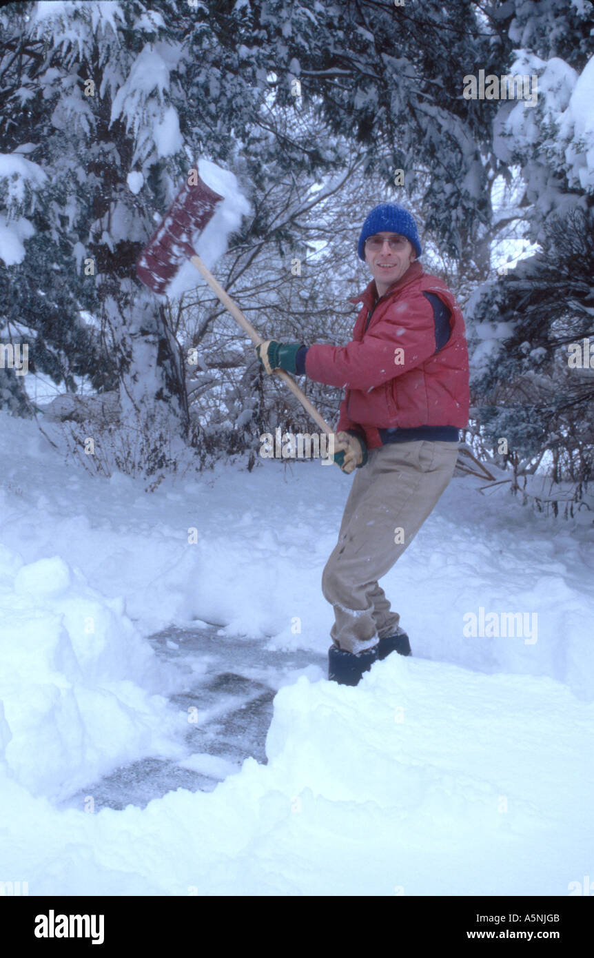 Man shoveling snow Stock Photo - Alamy