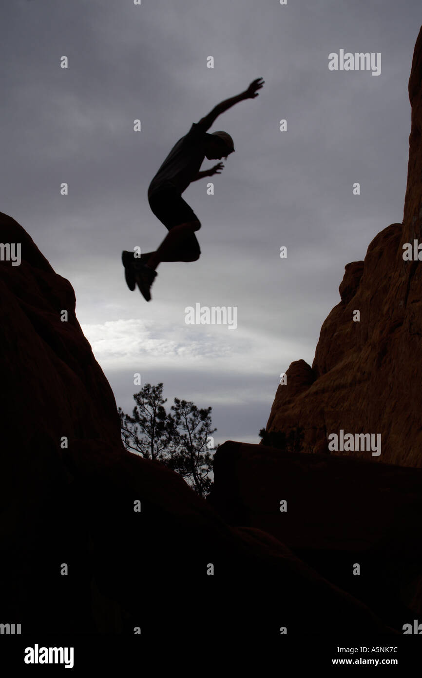 teenager jumping across gap Stock Photo - Alamy