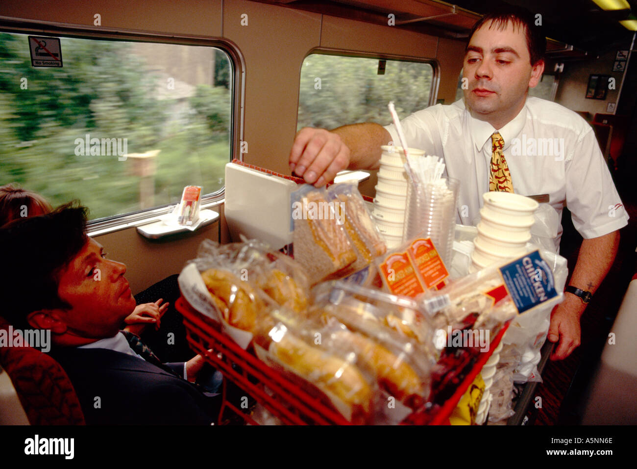 Trolly service selling drinks and snacks on board train Stock Photo - Alamy