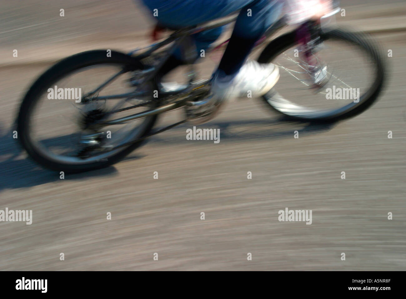 Panned image of child pedalling bicycle Stock Photo - Alamy