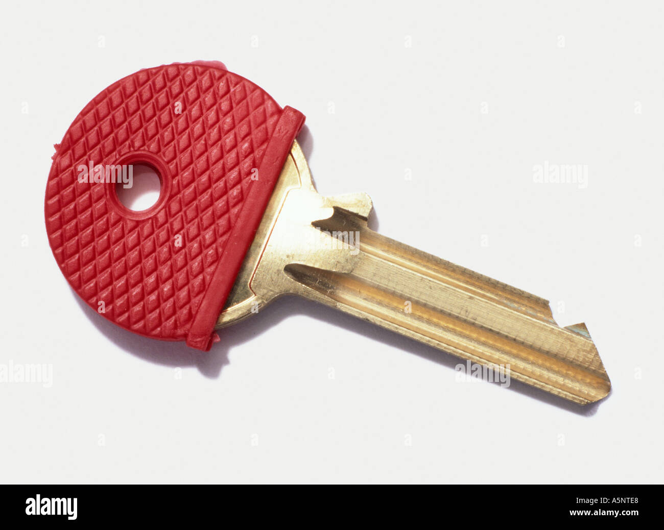 A gold coloured key Stock Photo - Alamy