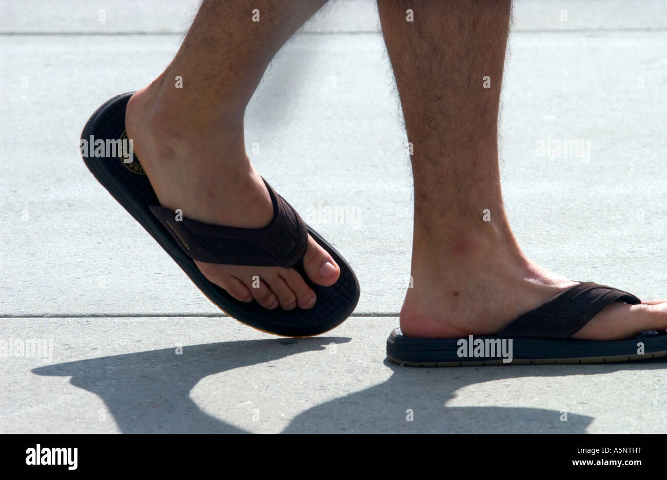 Adult male feet walking Stock Photo - Alamy