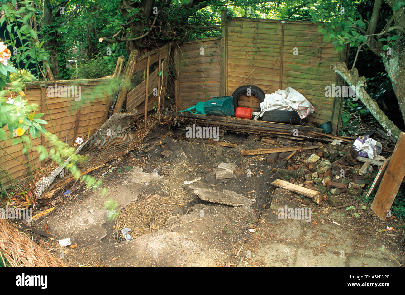 Dilapidated garden with broken fence before renovation Stock Photo - Alamy