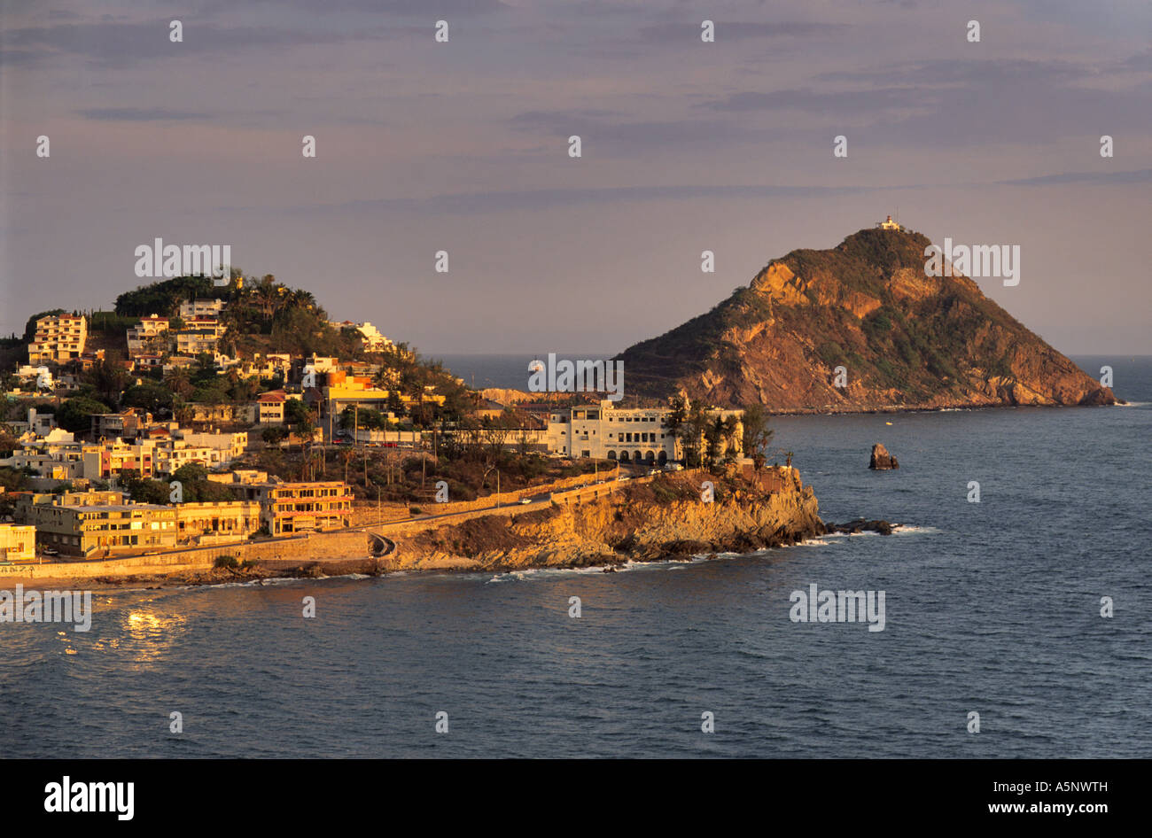 El Faro lighthouse in dist, from Cerro de la Neveria at sunset ...