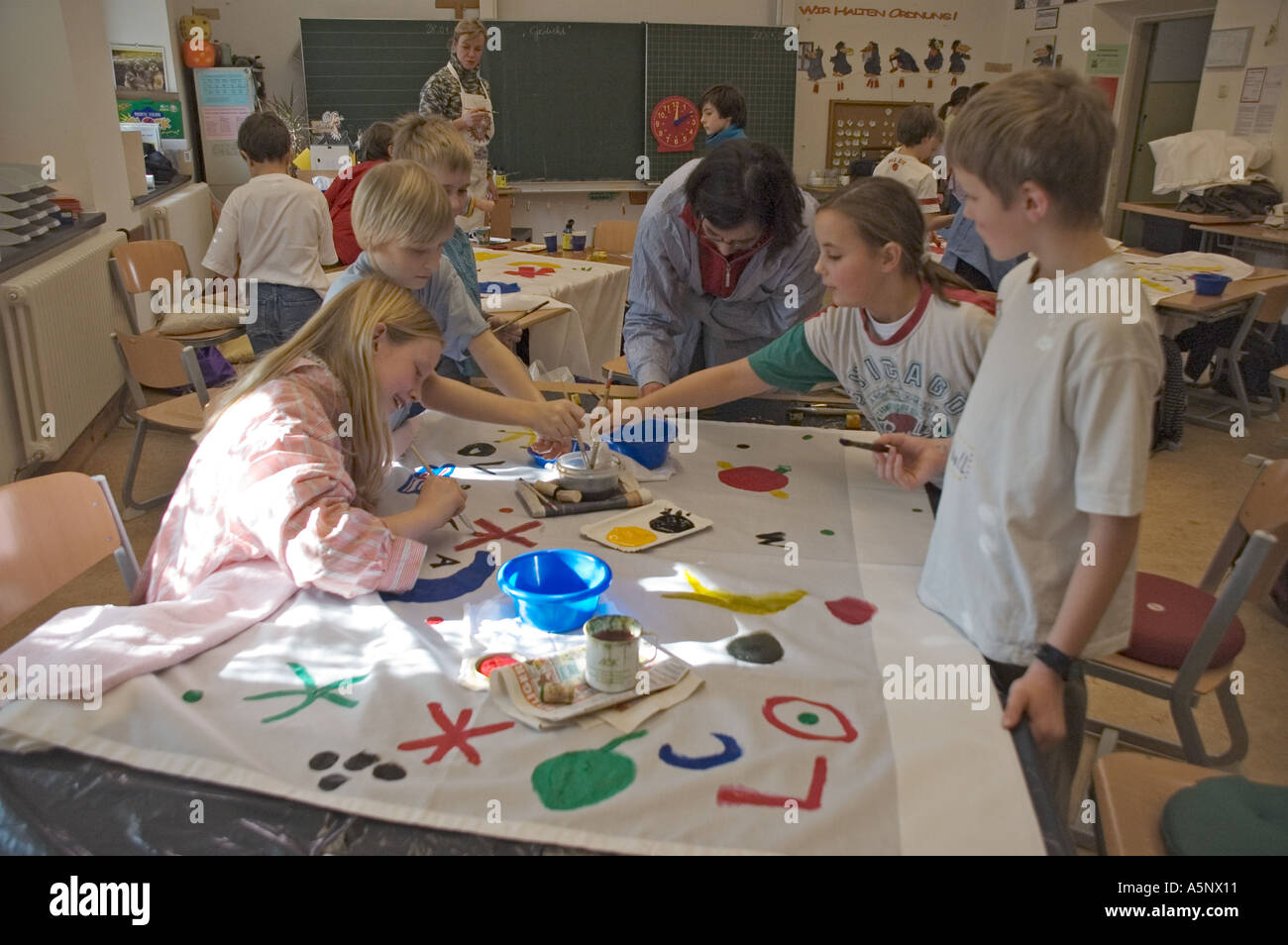 pupils of a 4th class in primary school painting on cloth Stock Photo ...