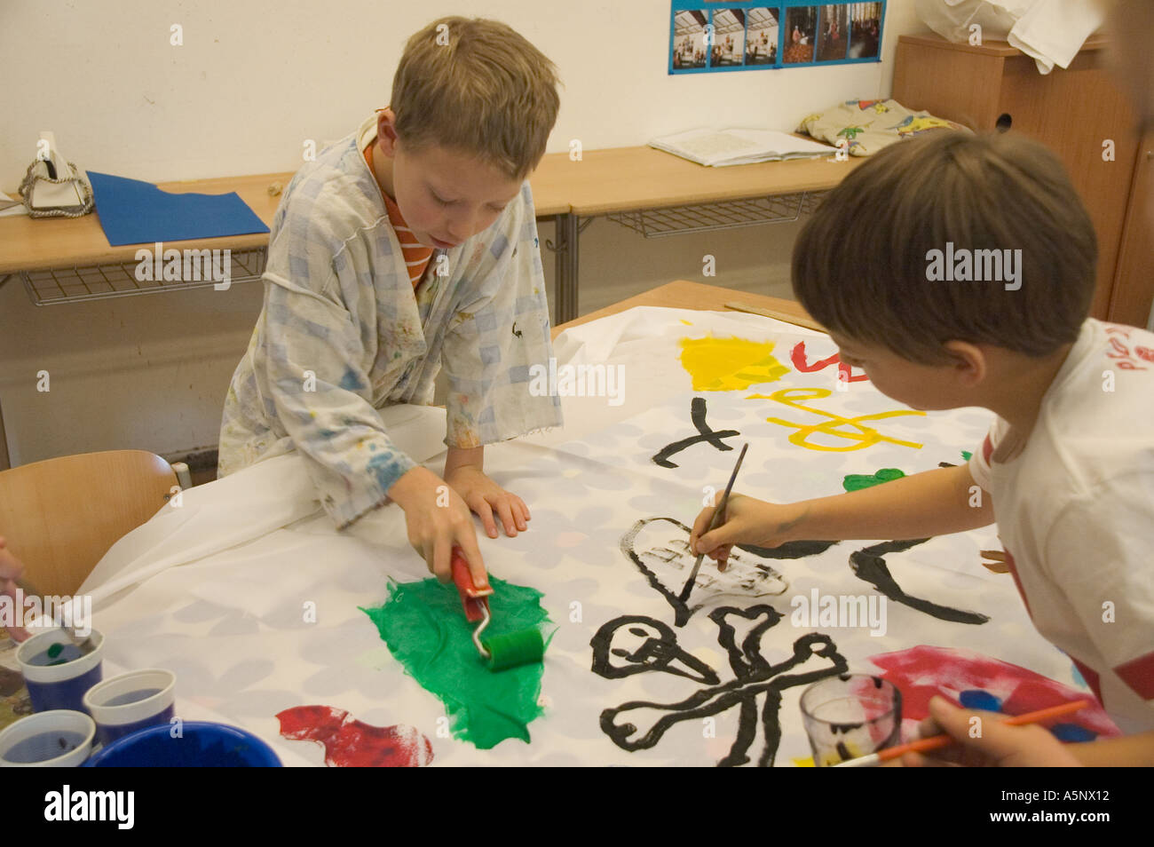 pupils of a 4th class in primary school painting on cloth Stock Photo ...