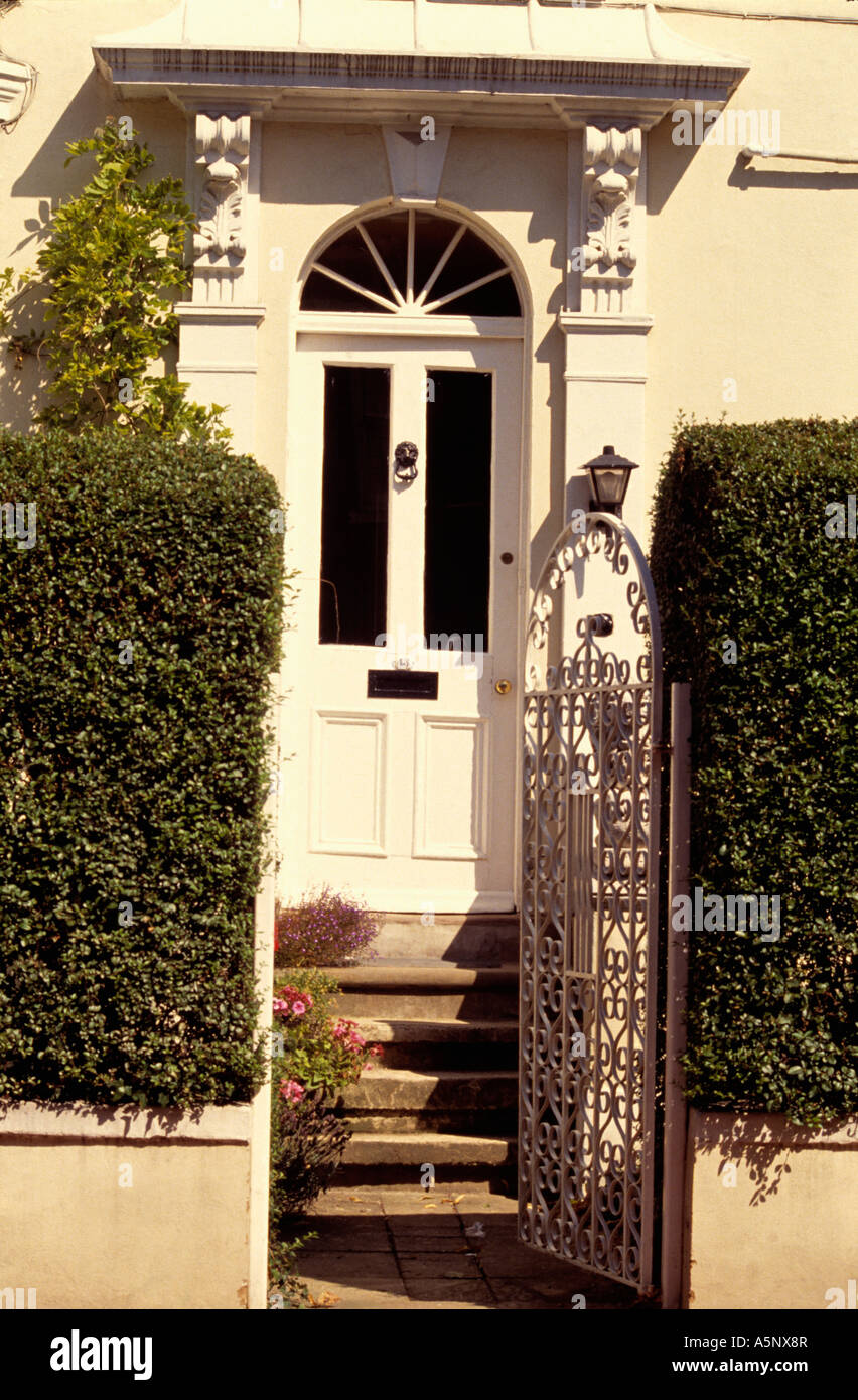 Steps up to white front door in small Victorian house Stock Photo - Alamy