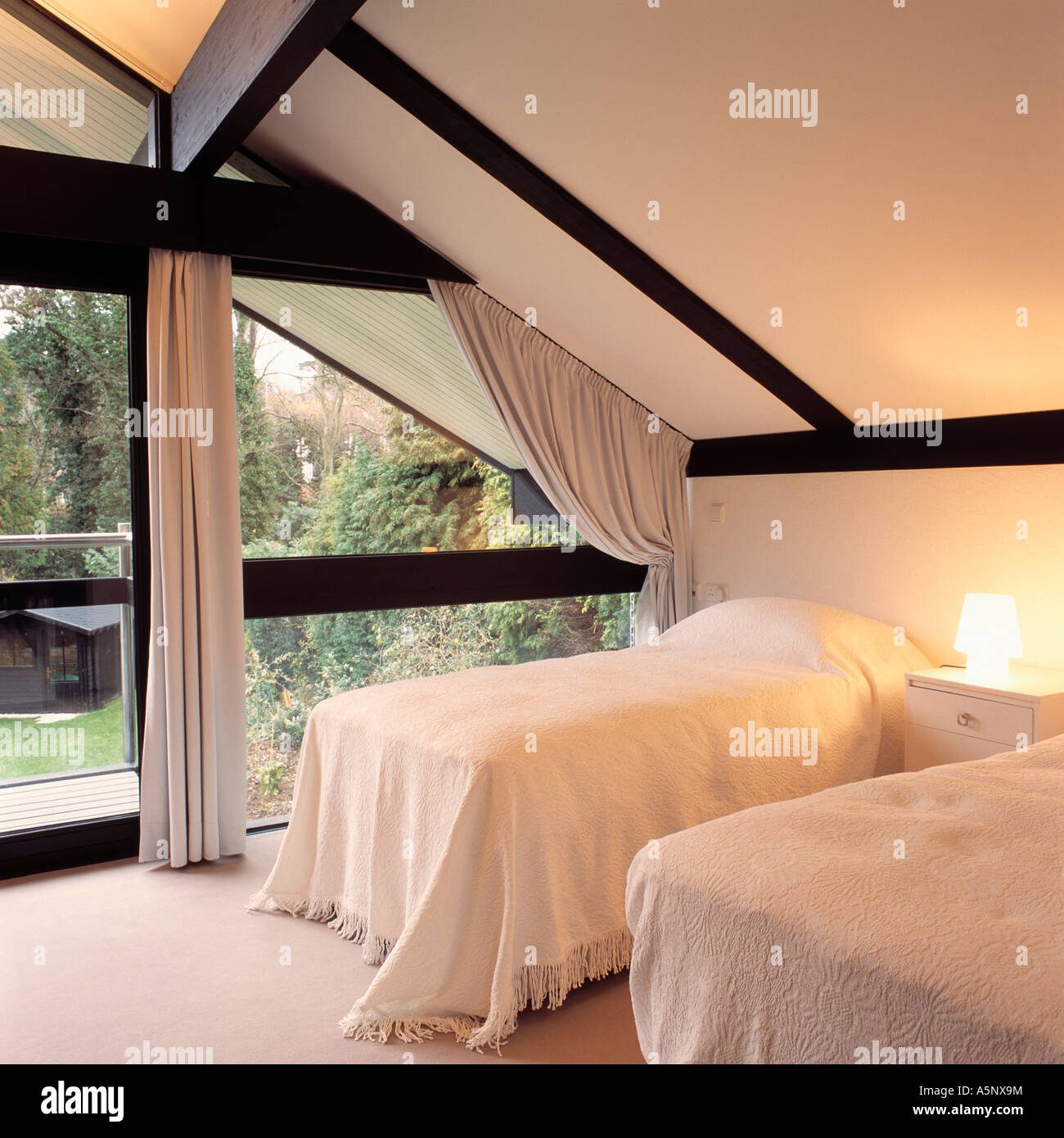 Bedroom with twin beds in loft conversion and window with view of ...