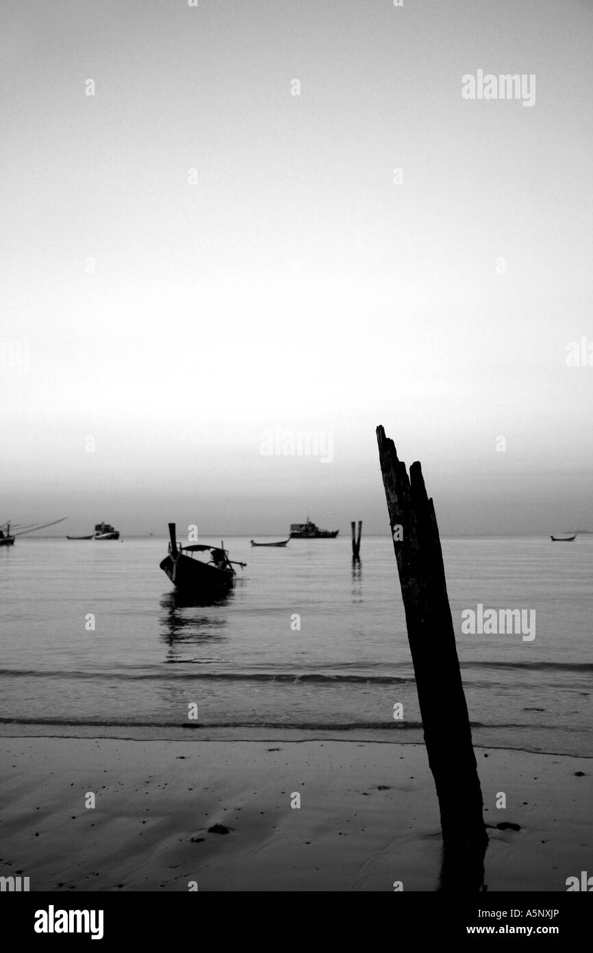 Traditional Thai Fishing Boats at Dawn light or sunrise The Andaman Sea Krabi Beach resort ...
