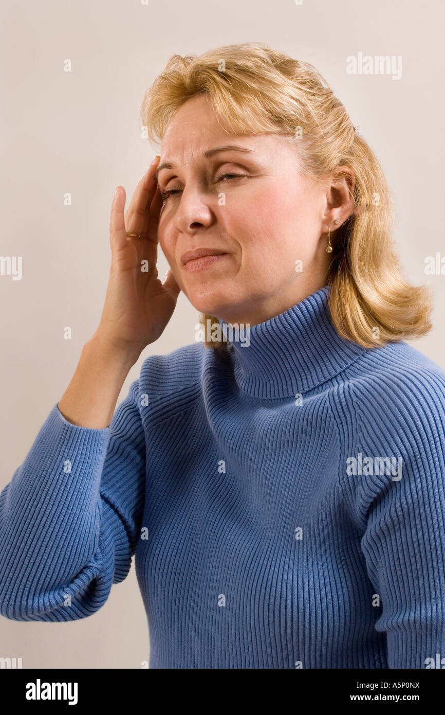 Middle age woman has a mild headache or a migraine Stock Photo - Alamy