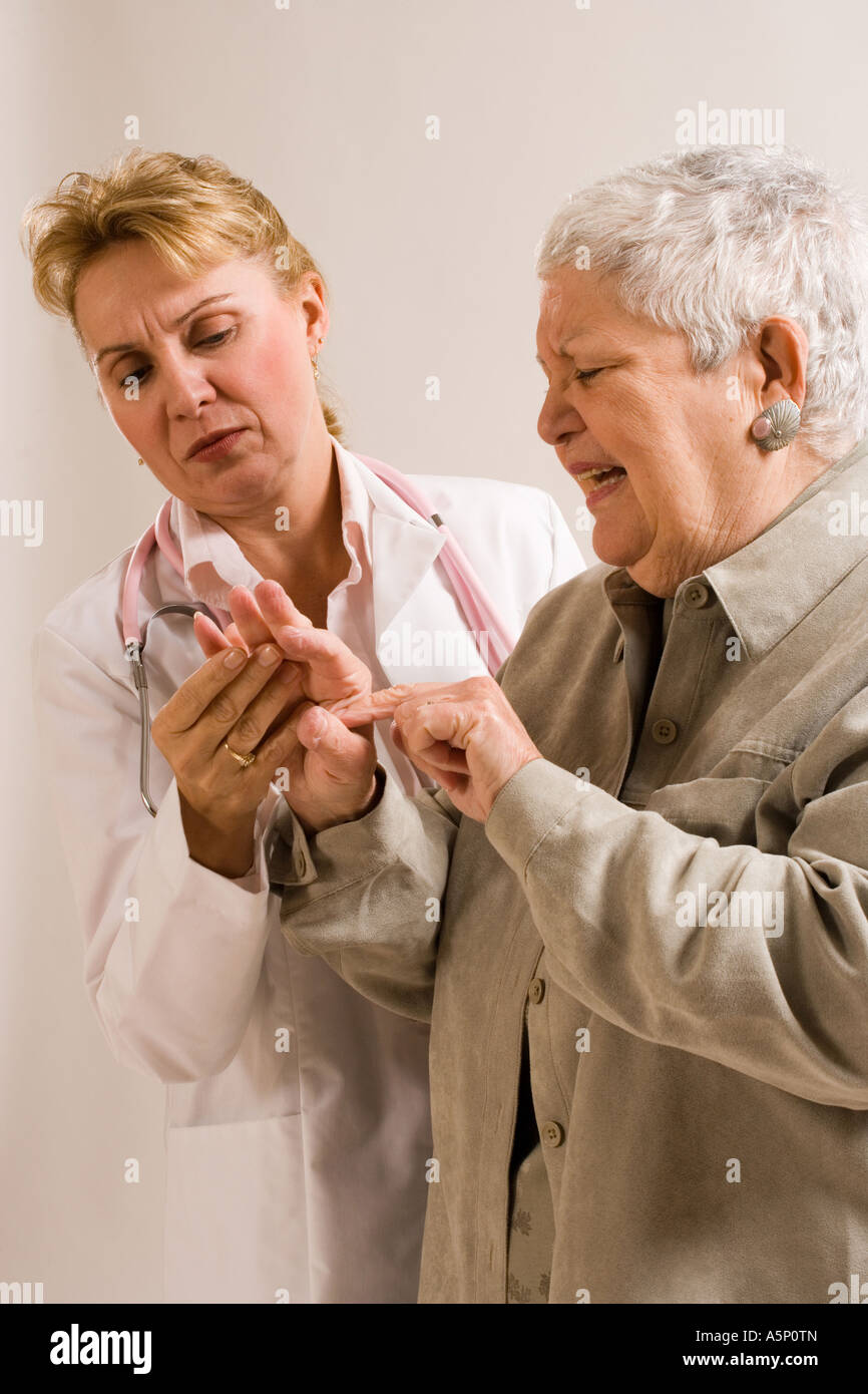 Rheumatologist doctor examines mature adult patient's hand Stock Photo ...