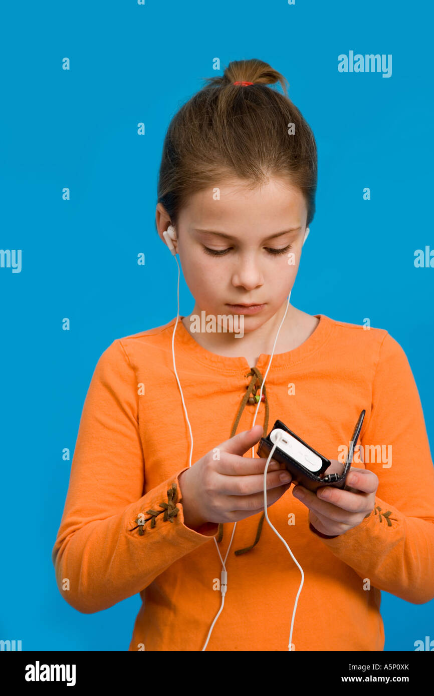 Listening to music using her digital mp3 player Stock Photo - Alamy