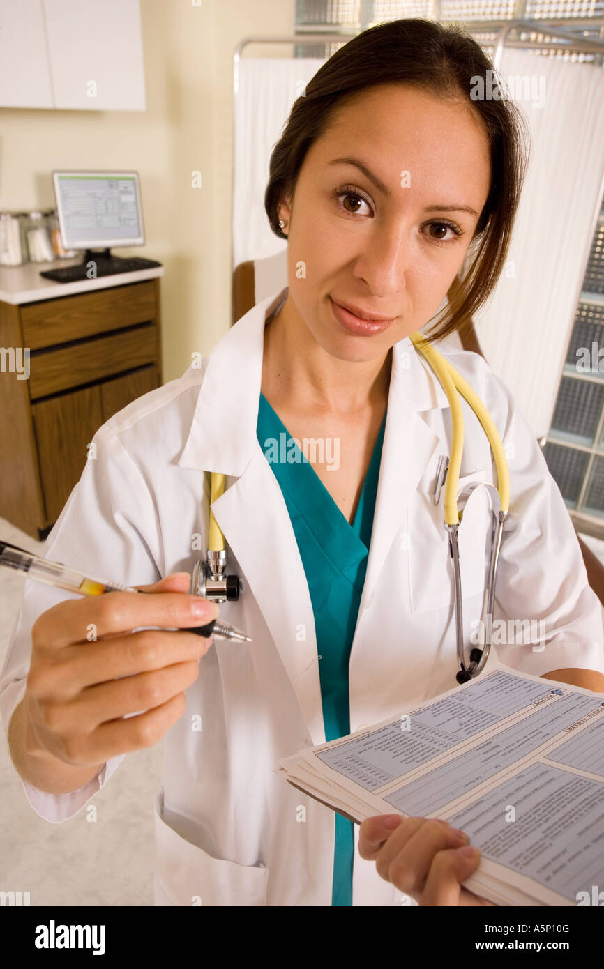 Hispanic doctor taking notes Stock Photo - Alamy
