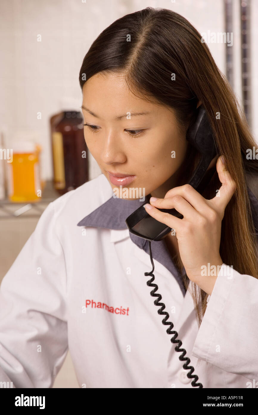 Pharmacist on the phone checking a prescription Stock Photo - Alamy