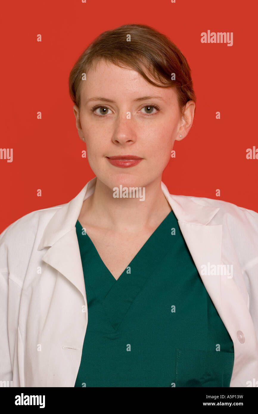 Female medical worker on red background Stock Photo - Alamy
