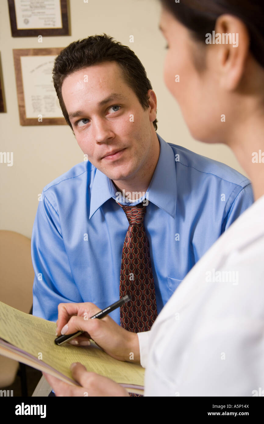 Doctor interviews patient history information Stock Photo - Alamy