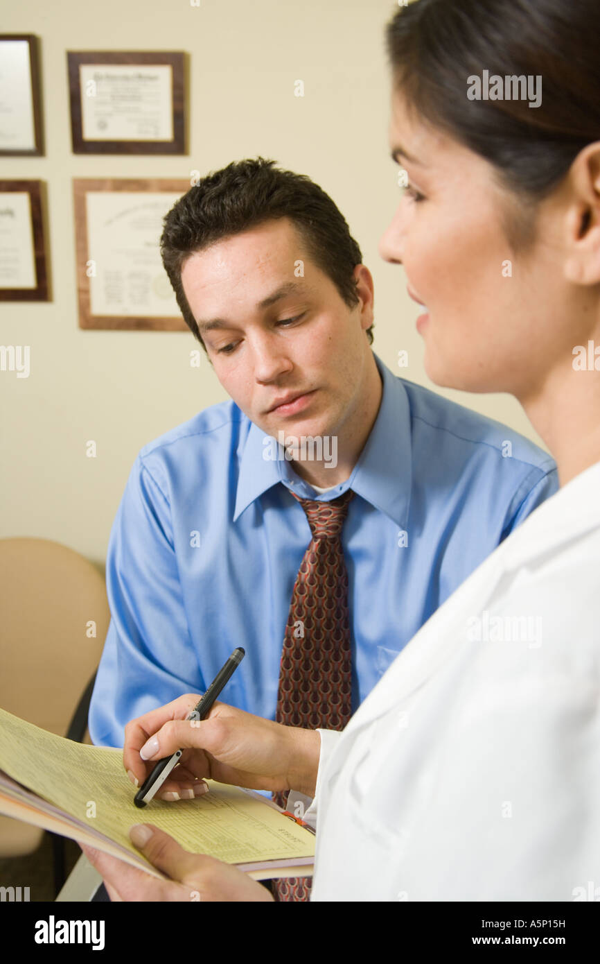 Male patient answers questions during a routine physical in the doctor ...
