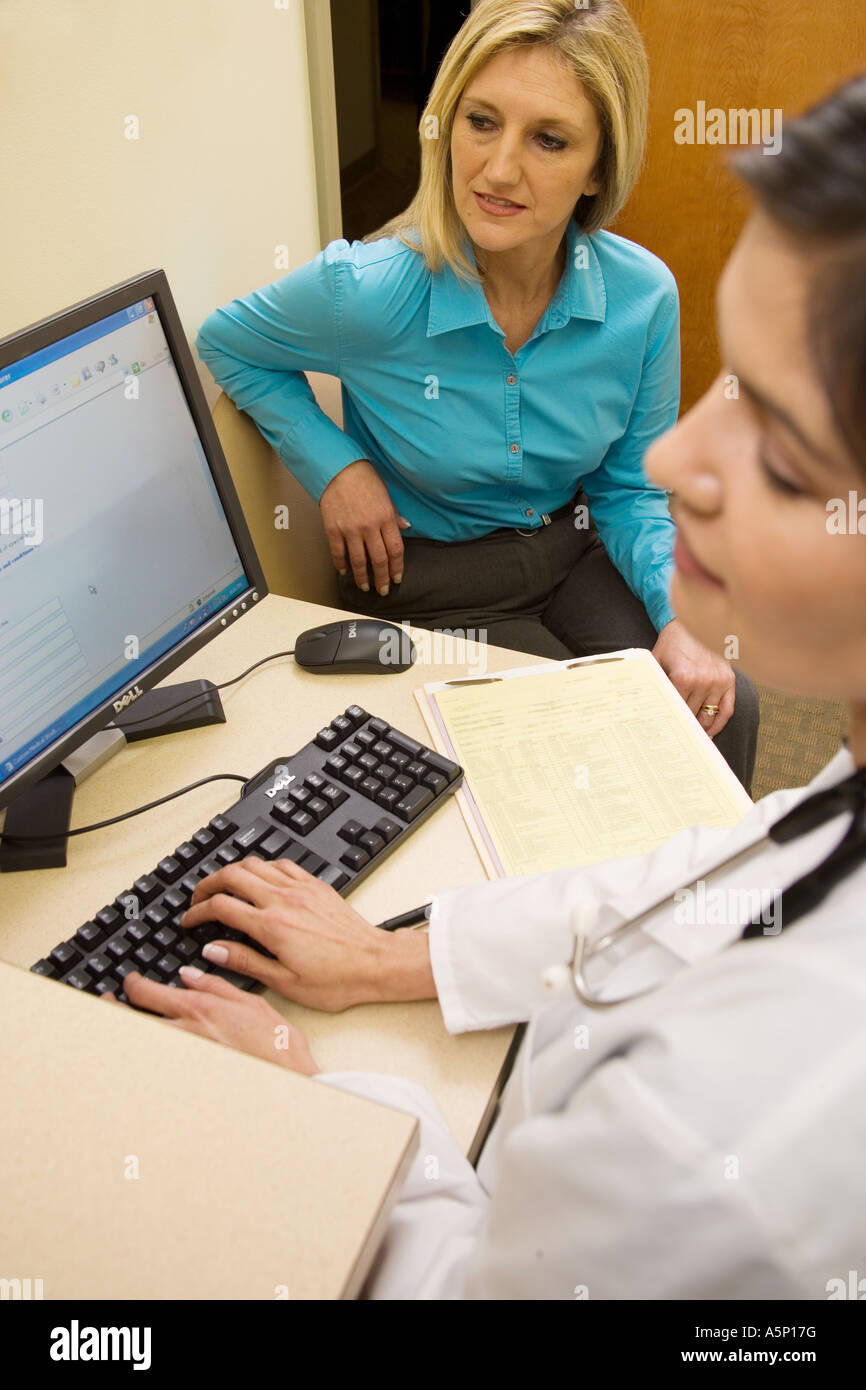 Doctor enters info into computer database Stock Photo - Alamy