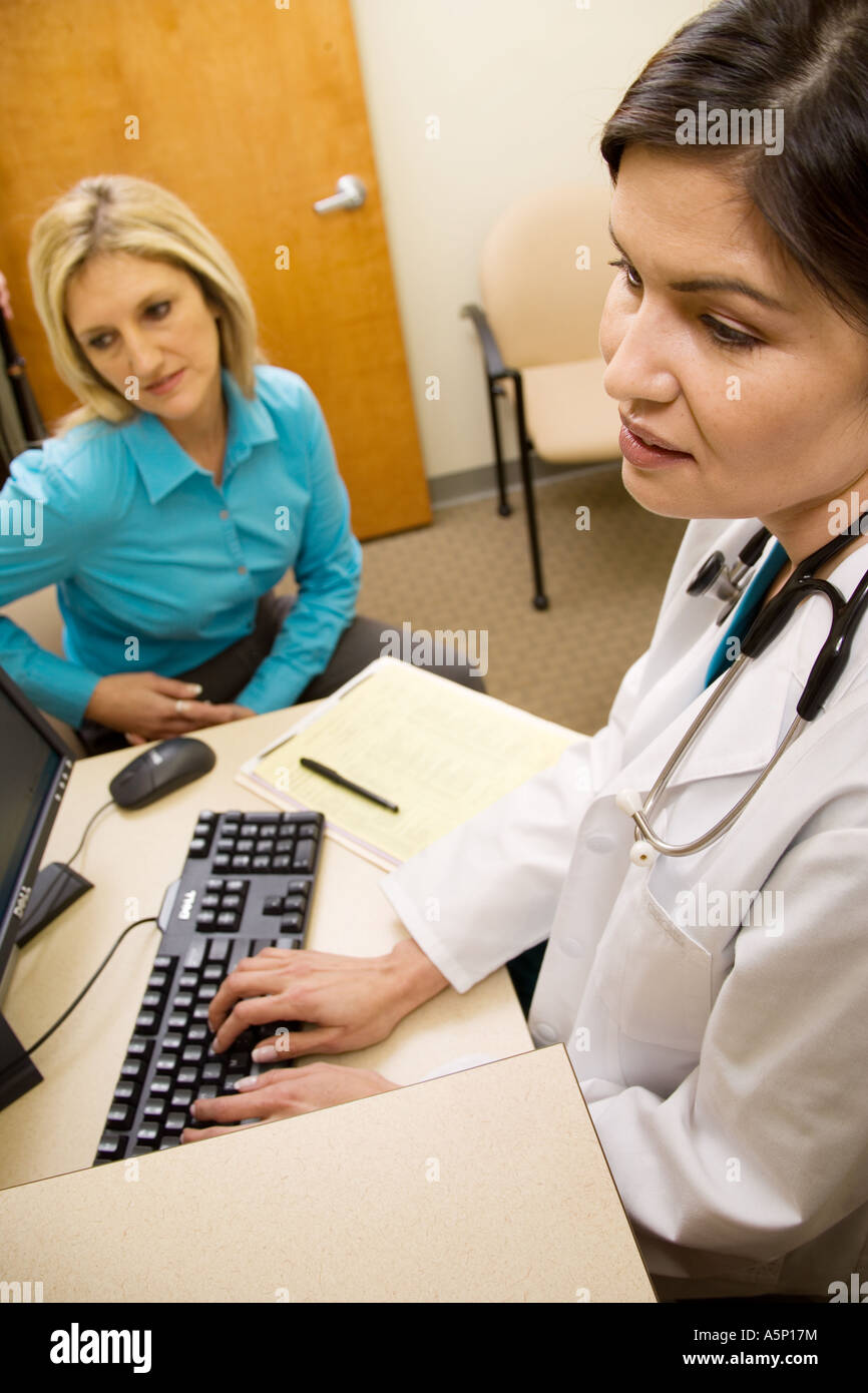 Native American physician having consultation with female patient Stock ...
