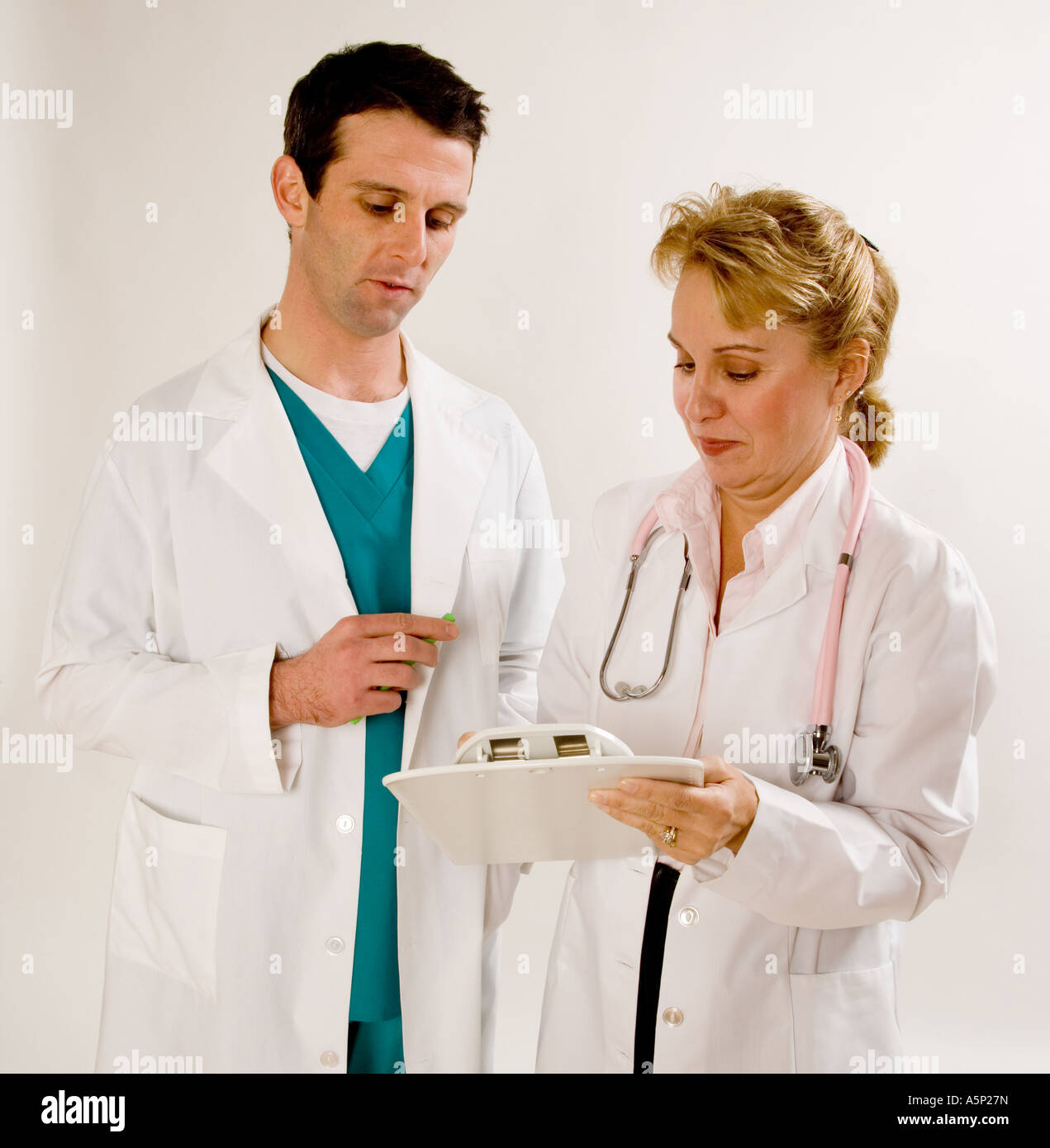 Surgeon confers with attending doctor about a patients diagnosis Stock ...