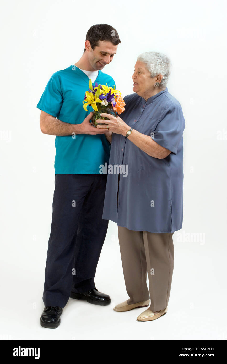Patient gives flowers to her caregiver. OR Caregiver gives flowers to ...