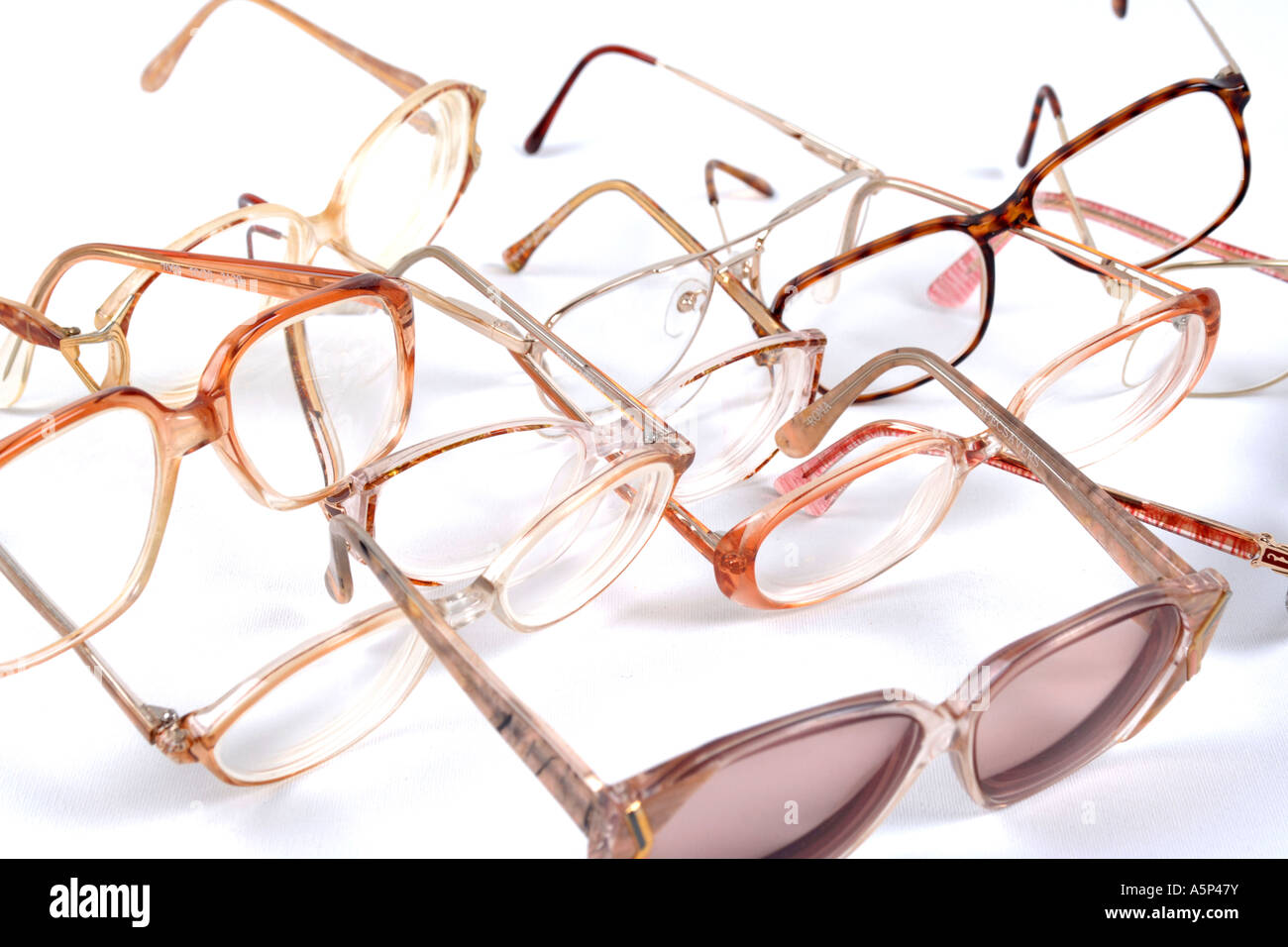 Different pairs of spectacles against a white background Stock Photo ...
