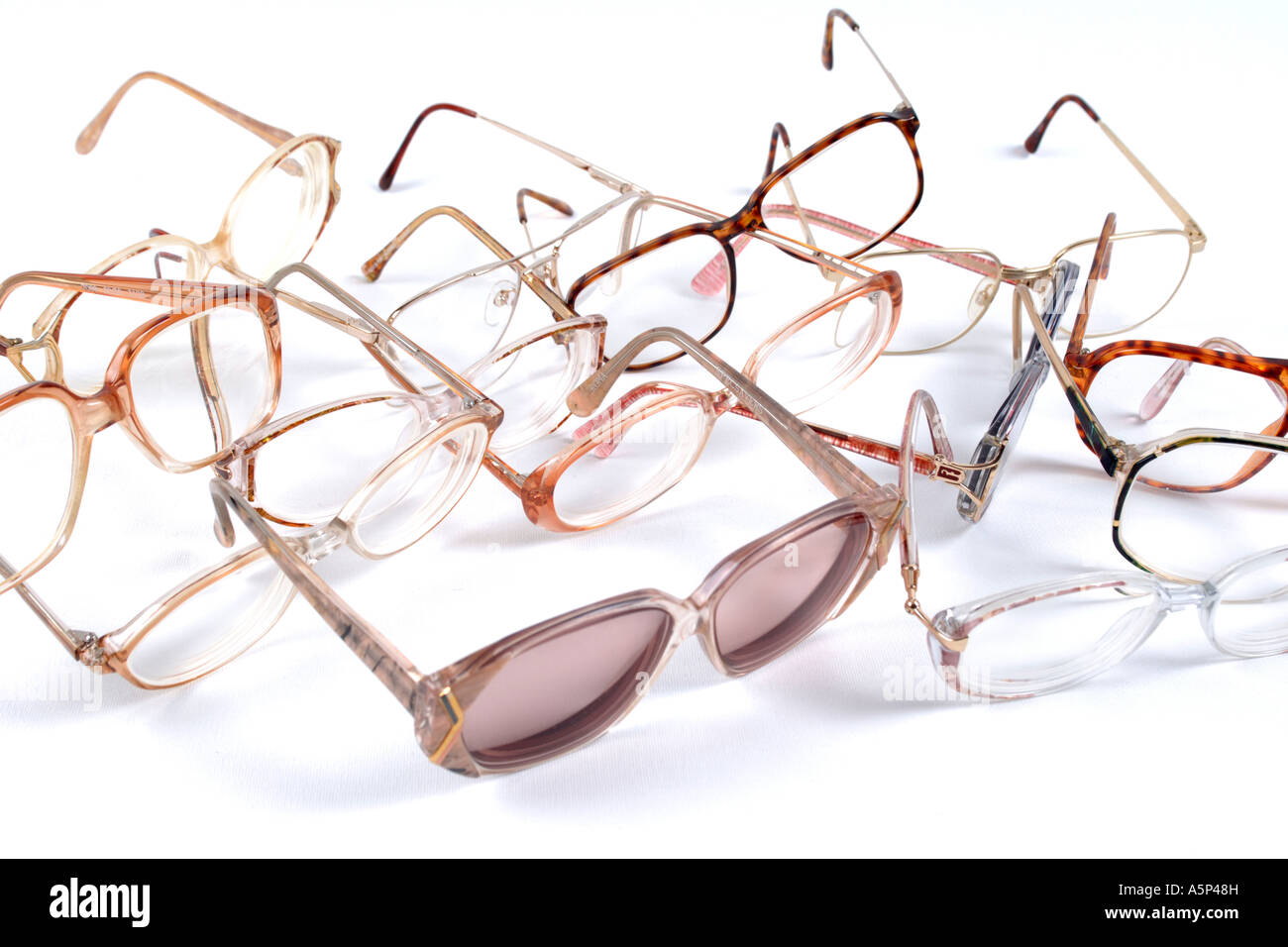 Different pairs of spectacles against a white background Stock Photo ...
