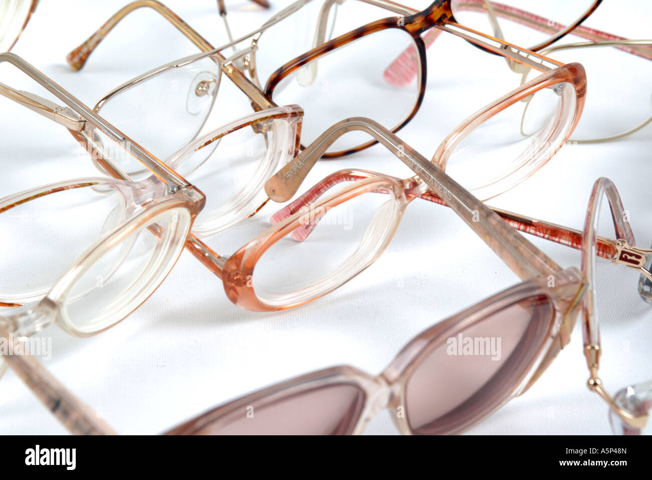 Different pairs of spectacles against a white background Stock Photo ...