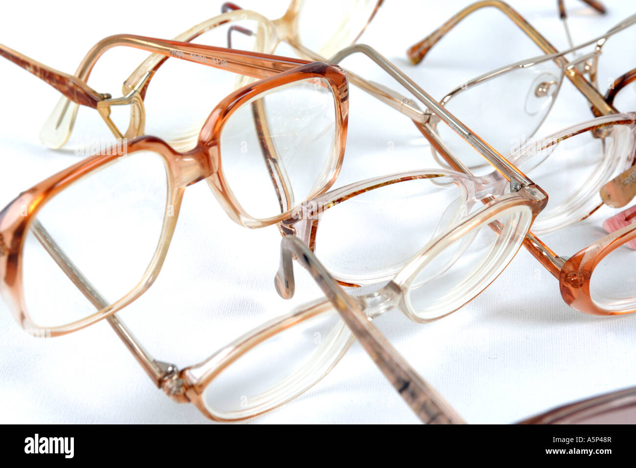 Different pairs of spectacles against a white background Stock Photo ...
