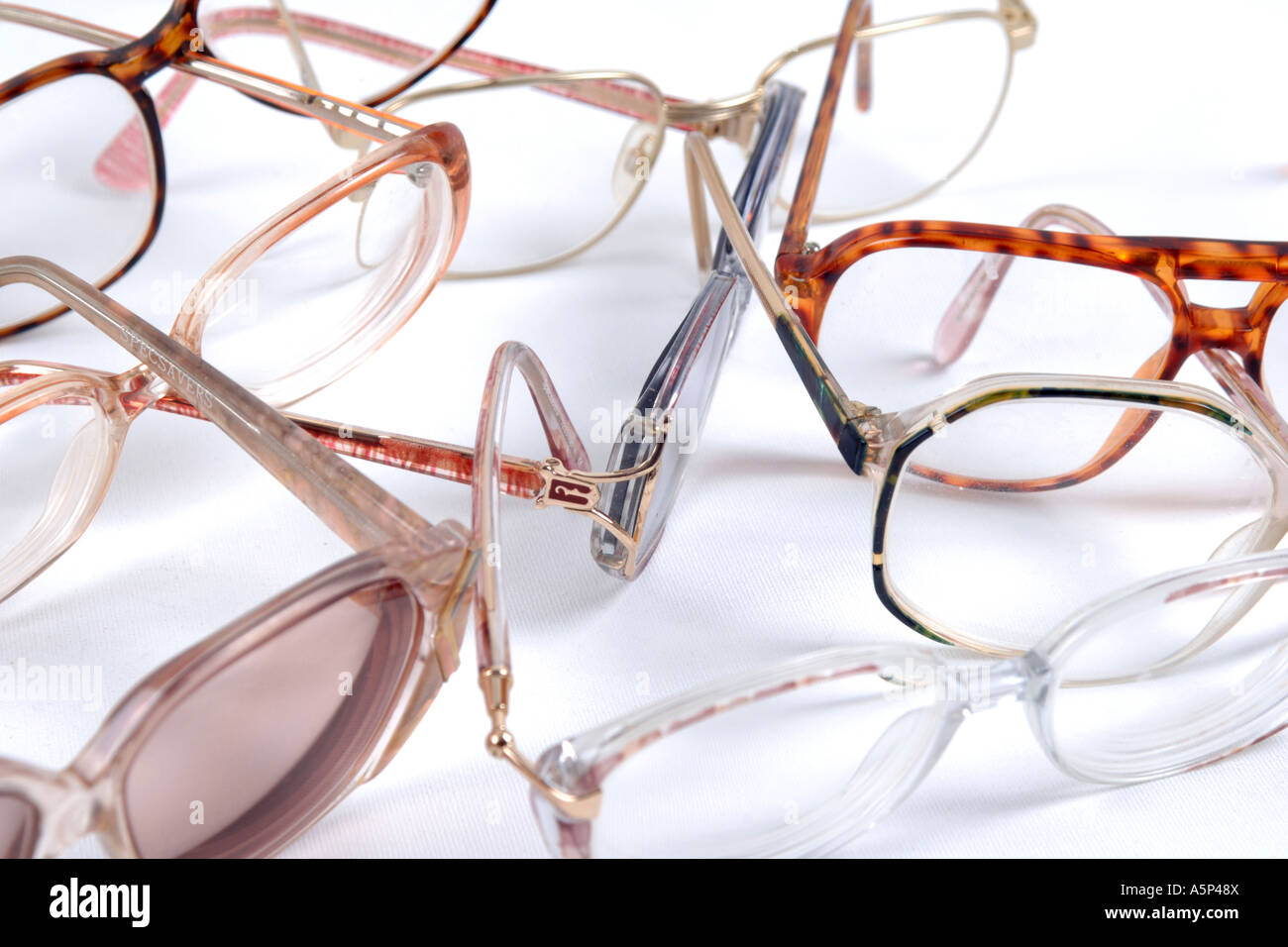 Different pairs of spectacles against a white background Stock Photo ...