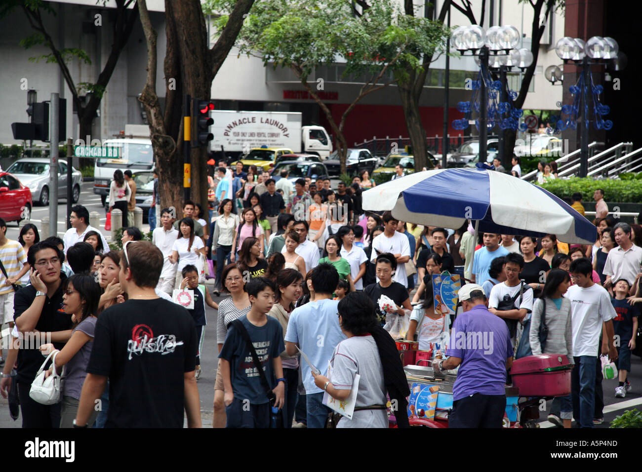Crowd of people shopping along Orchard Road in Singapore crossing the ...