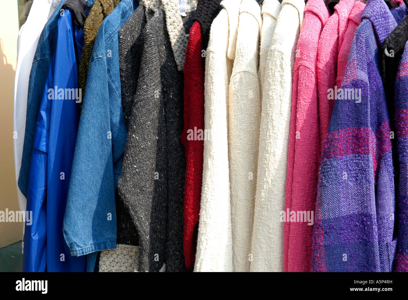 A rack of colorful clothes outside a store Stock Photo - Alamy