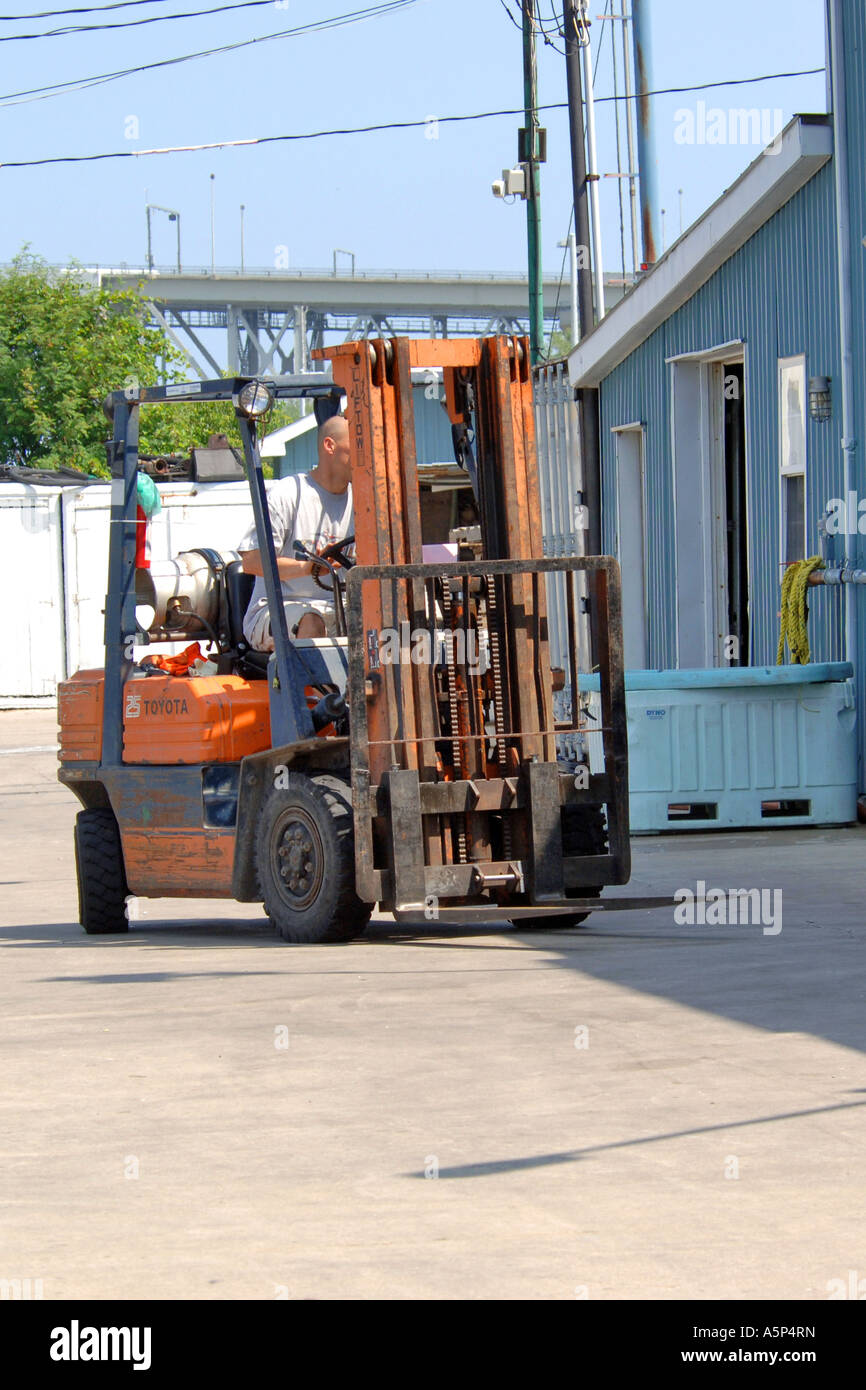 A Forklift truck moving cargo around a factory loading bay in Michigan ...