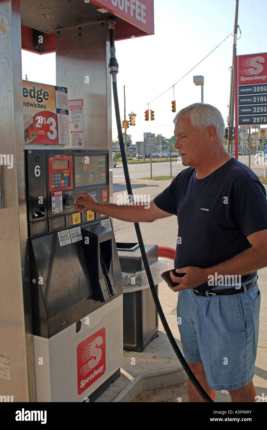 Adult male using his credit card at a fuel pump automated machine Stock ...