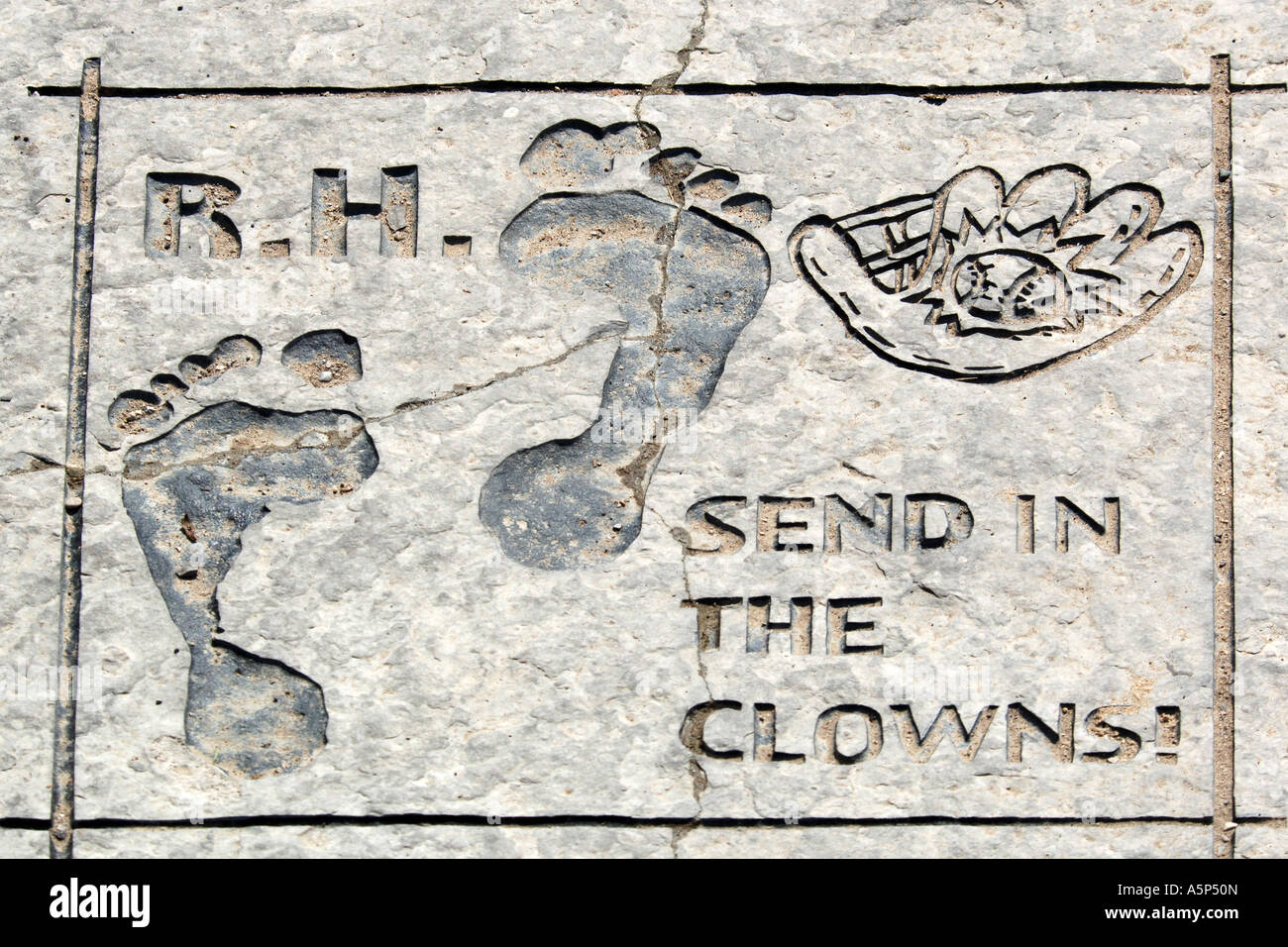 Footprint message in cement - Send in the clowns Stock Photo - Alamy