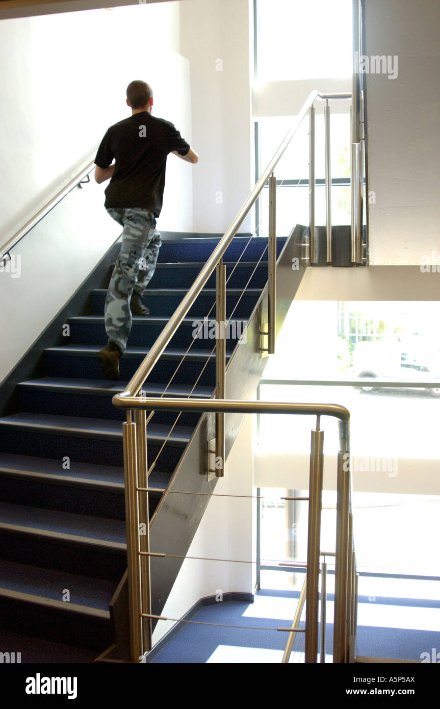 Student running up stairs hi-res stock photography and images - Alamy