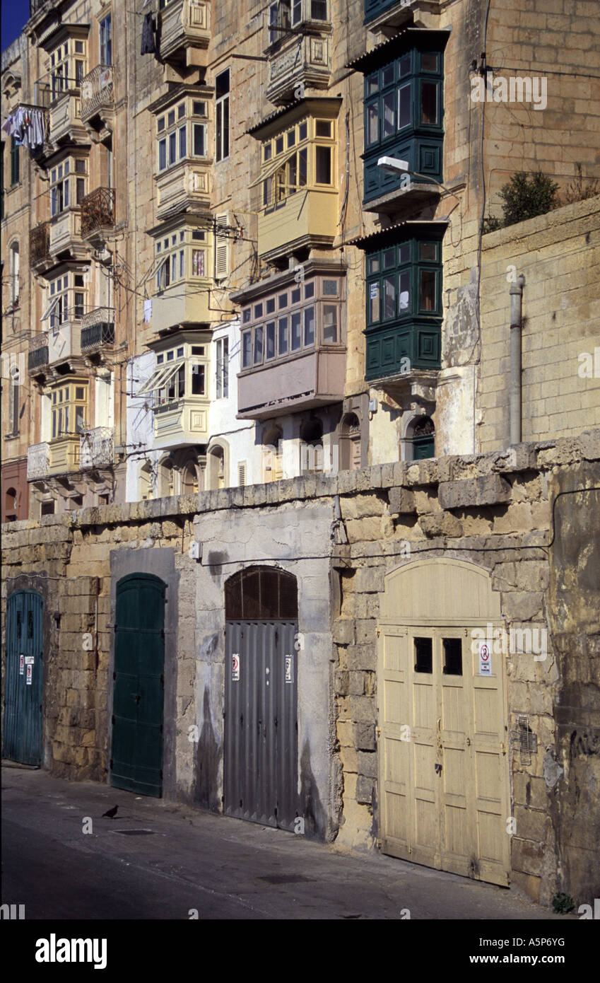 Building frontage. Apartments and flats above garage doors, Valletta ...